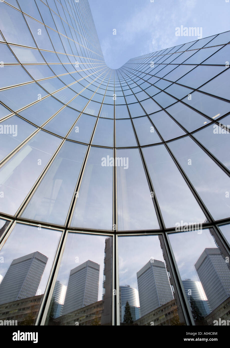 Skyscraper with reflection of buildings on facade, low angle, abstract ...