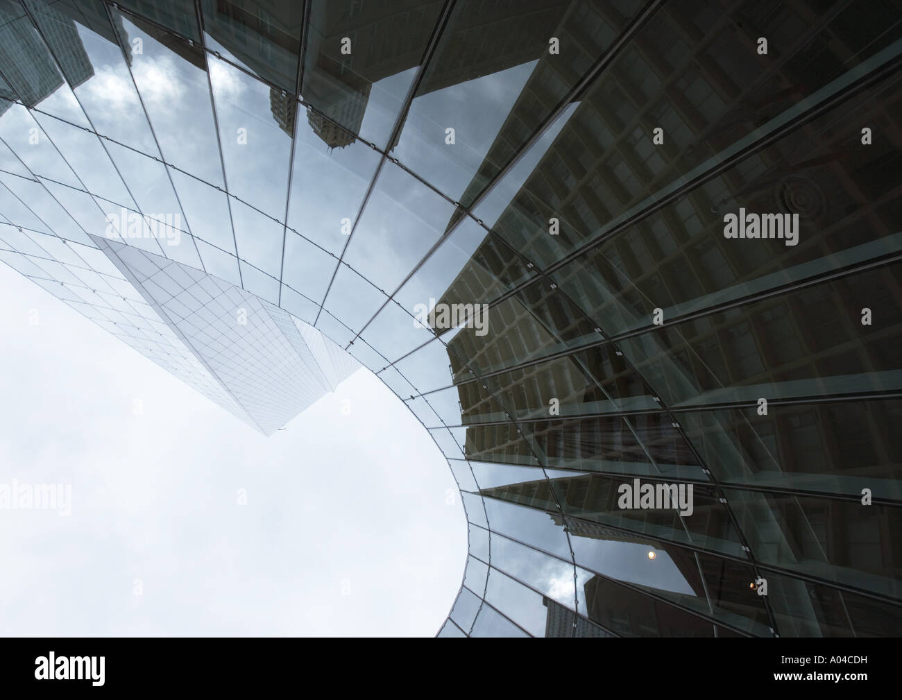 Skyscraper with reflection of buildings on facade, low angle, abstract ...