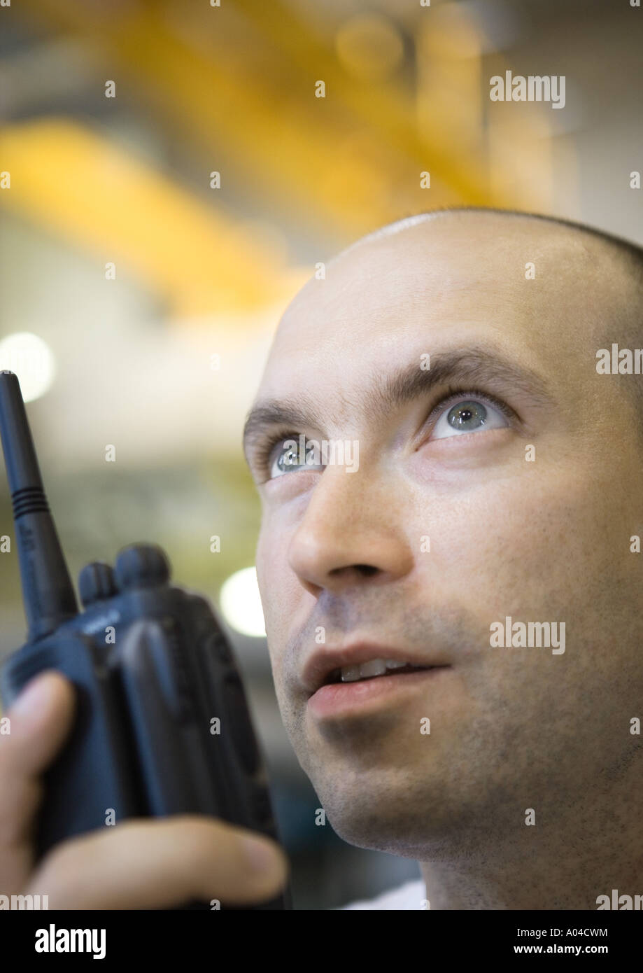 Factory worker using walkie-talkie Stock Photo - Alamy