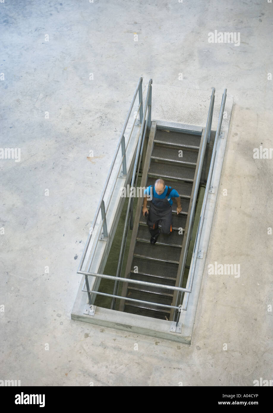 Man going down stairs, high angle view Stock Photo - Alamy