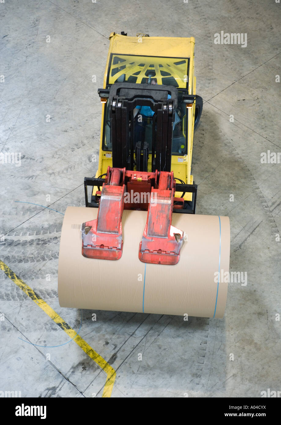 Forklift transporting roll of paper in warehouse Stock Photo - Alamy