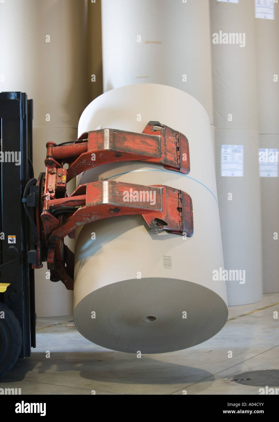 Forklift transporting roll of paper in warehouse Stock Photo - Alamy