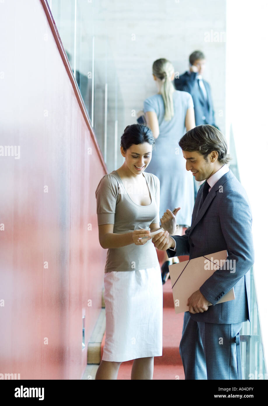 Executives standing, speaking and exchanging business card Stock Photo ...