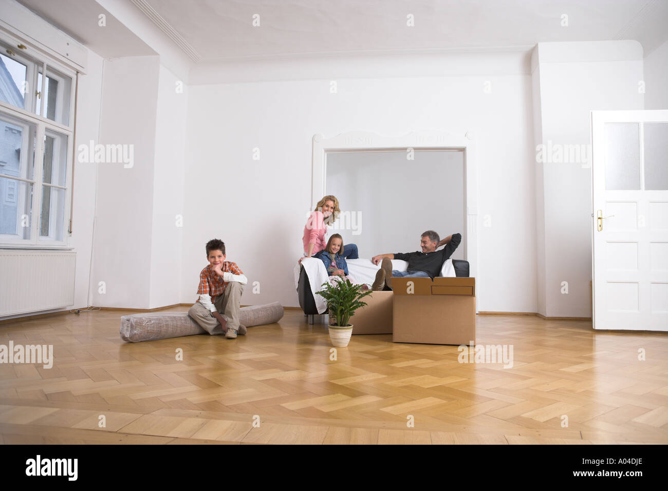 family in empty room moving house into new home Stock Photo - Alamy