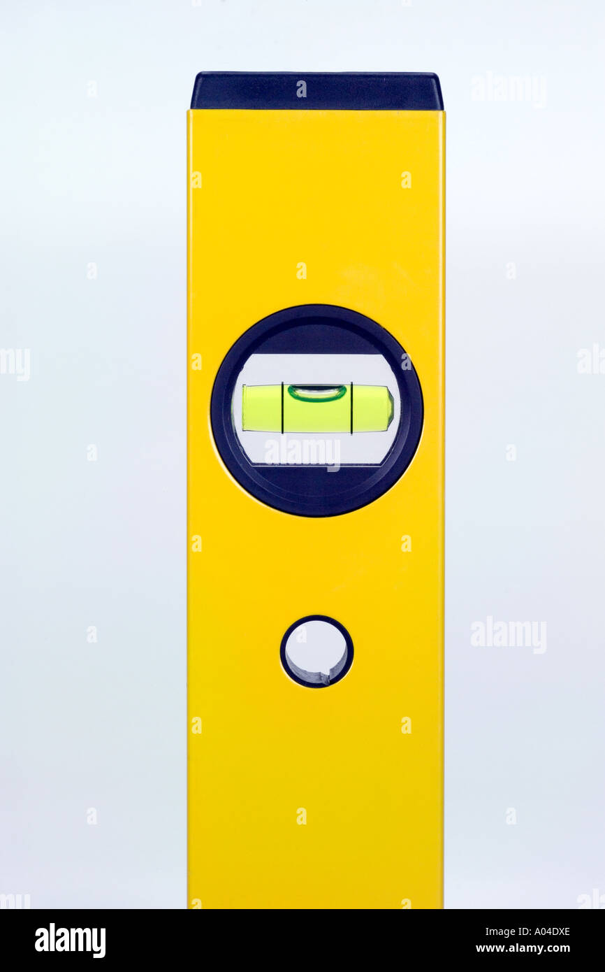 Yellow builders spirit level with green bubble Stock Photo - Alamy