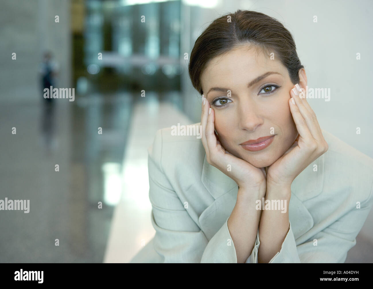 Woman cupping head in hands Stock Photo - Alamy
