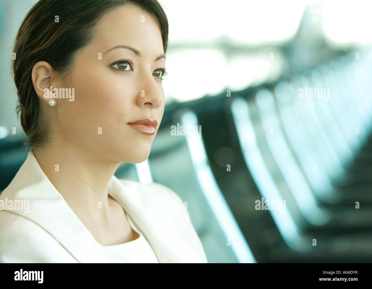Woman sitting in airport lounge Stock Photo - Alamy