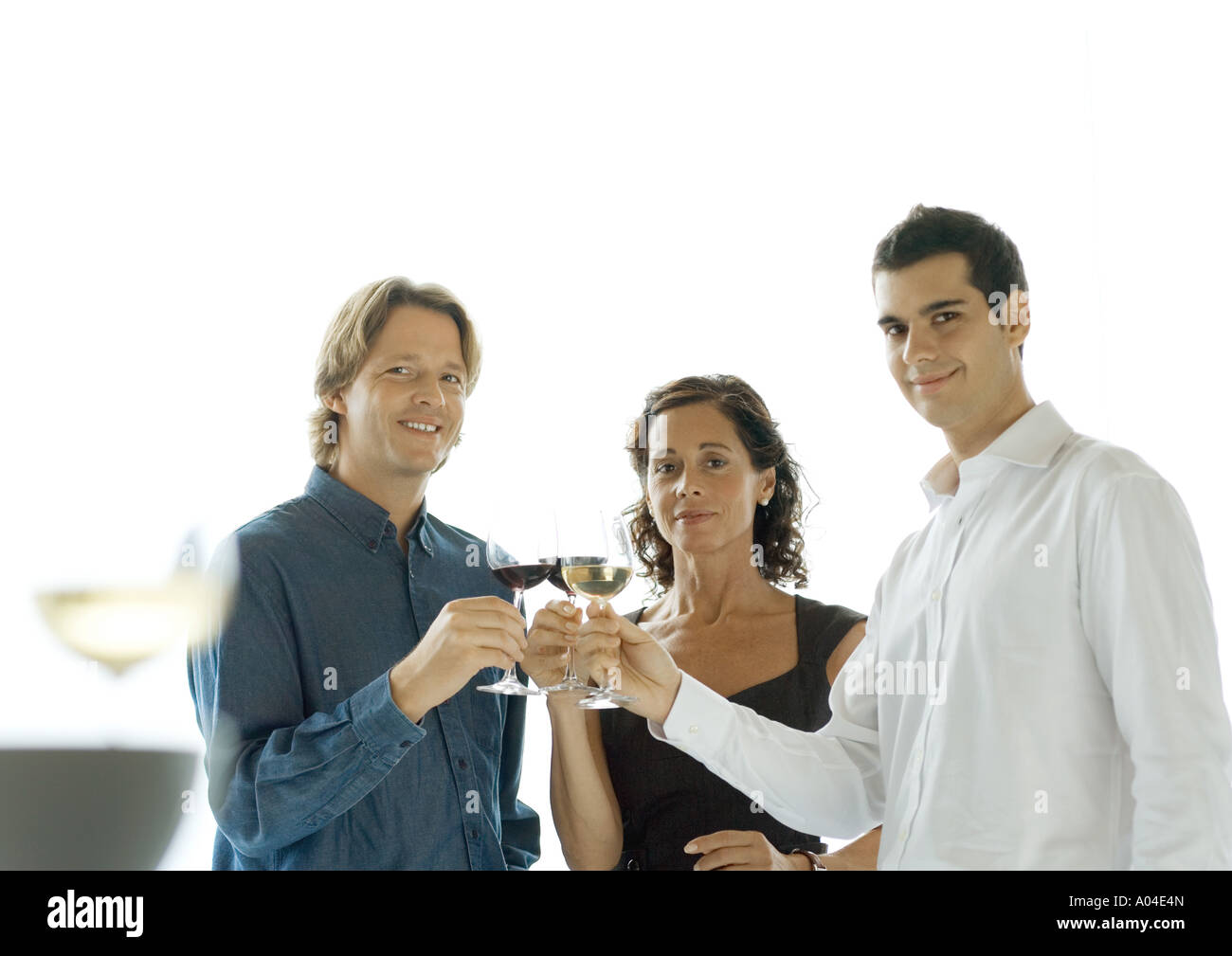 Three people clinking glasses of wine Stock Photo - Alamy