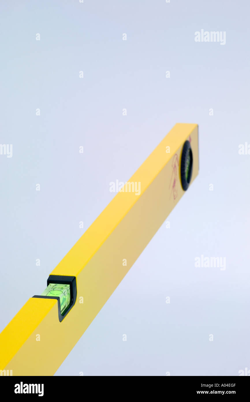 Yellow builders spirit level with green bubble Stock Photo - Alamy