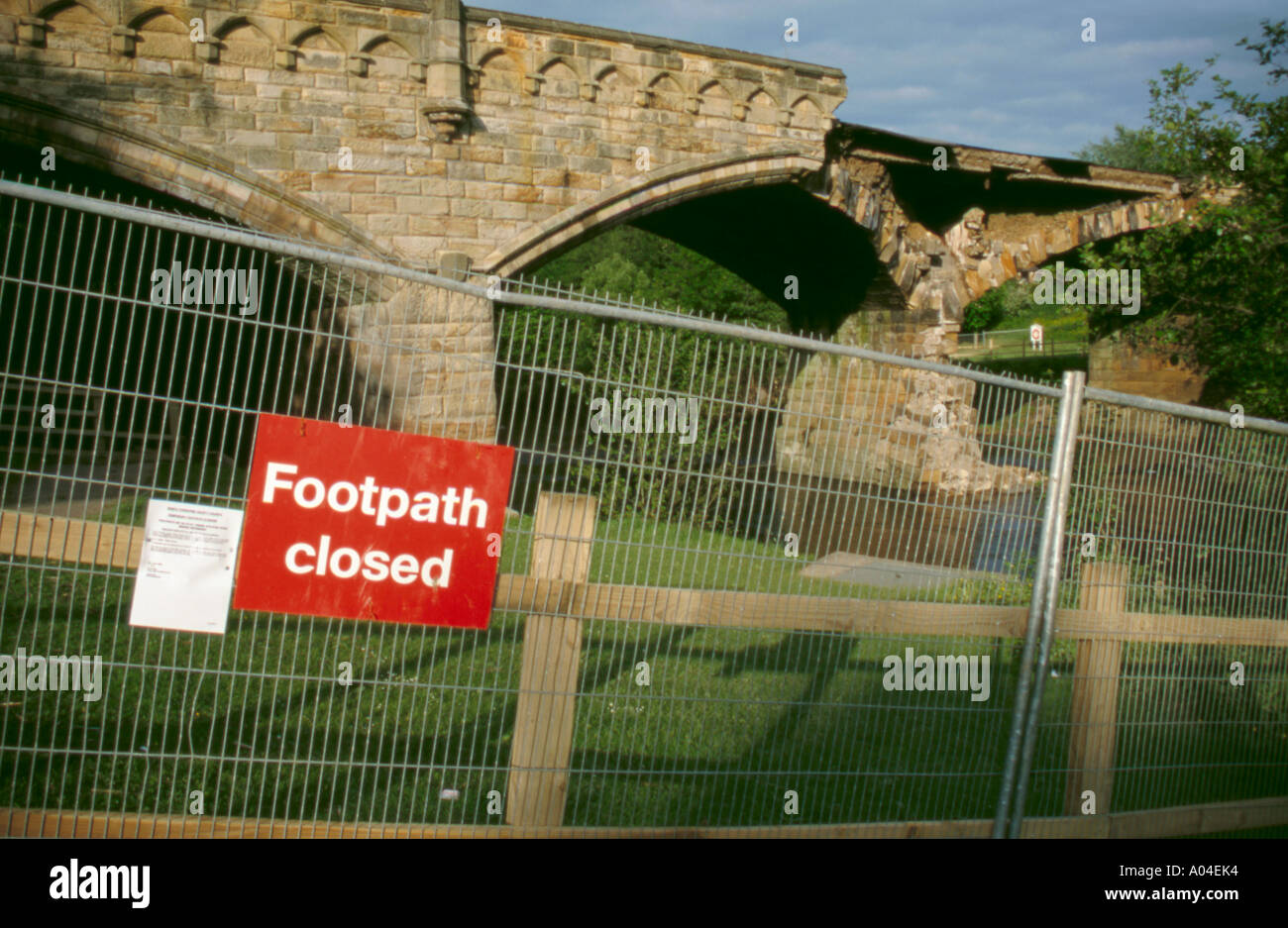 Flood damaged, partially collapsed old stone masonry bridge over the ...
