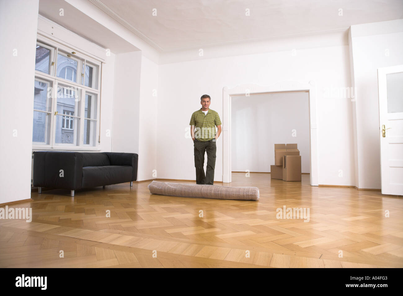 portrait of man standing in his new home Stock Photo - Alamy