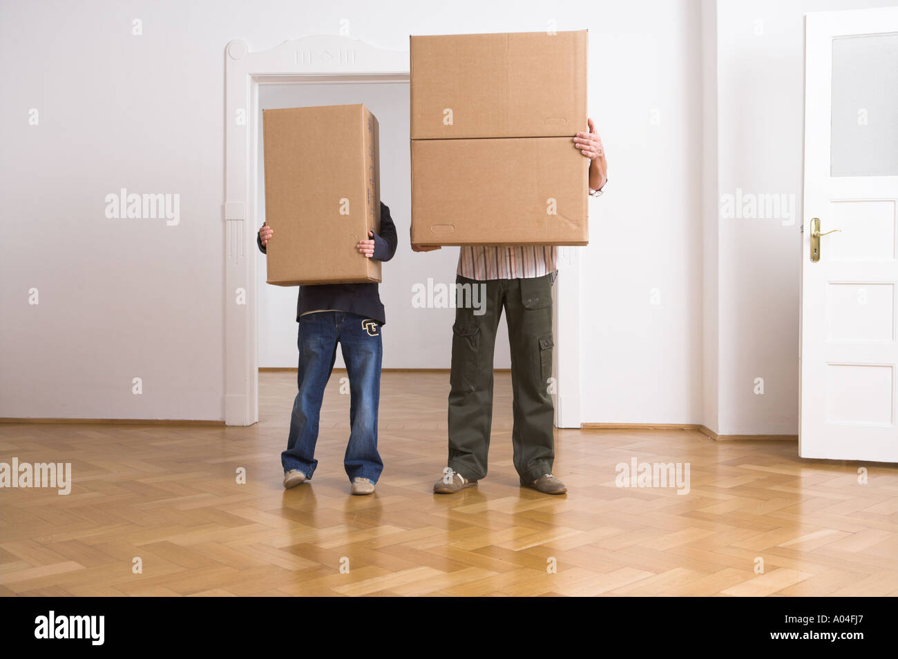 boy and man hidden behind cardboard boxes while moving house Stock ...