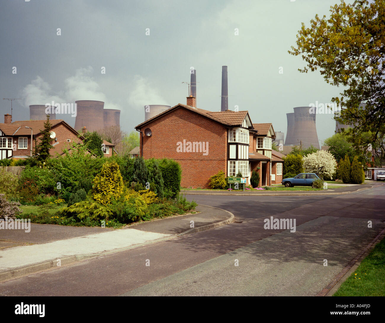 Environment houses in shadow of power station Stock Photo - Alamy
