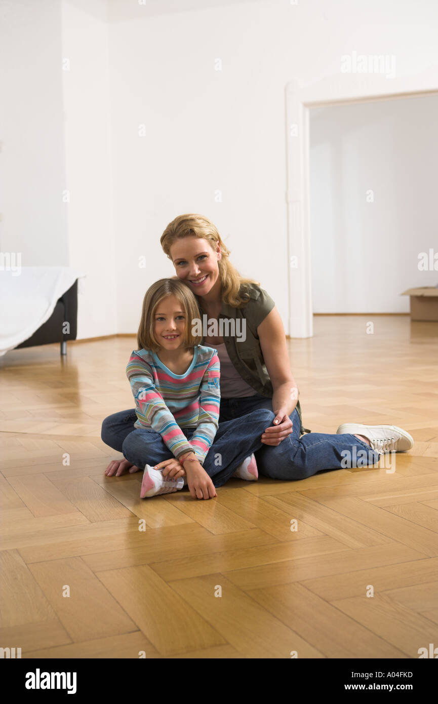 portrait of mother and daughter in empty room in their new home Stock ...