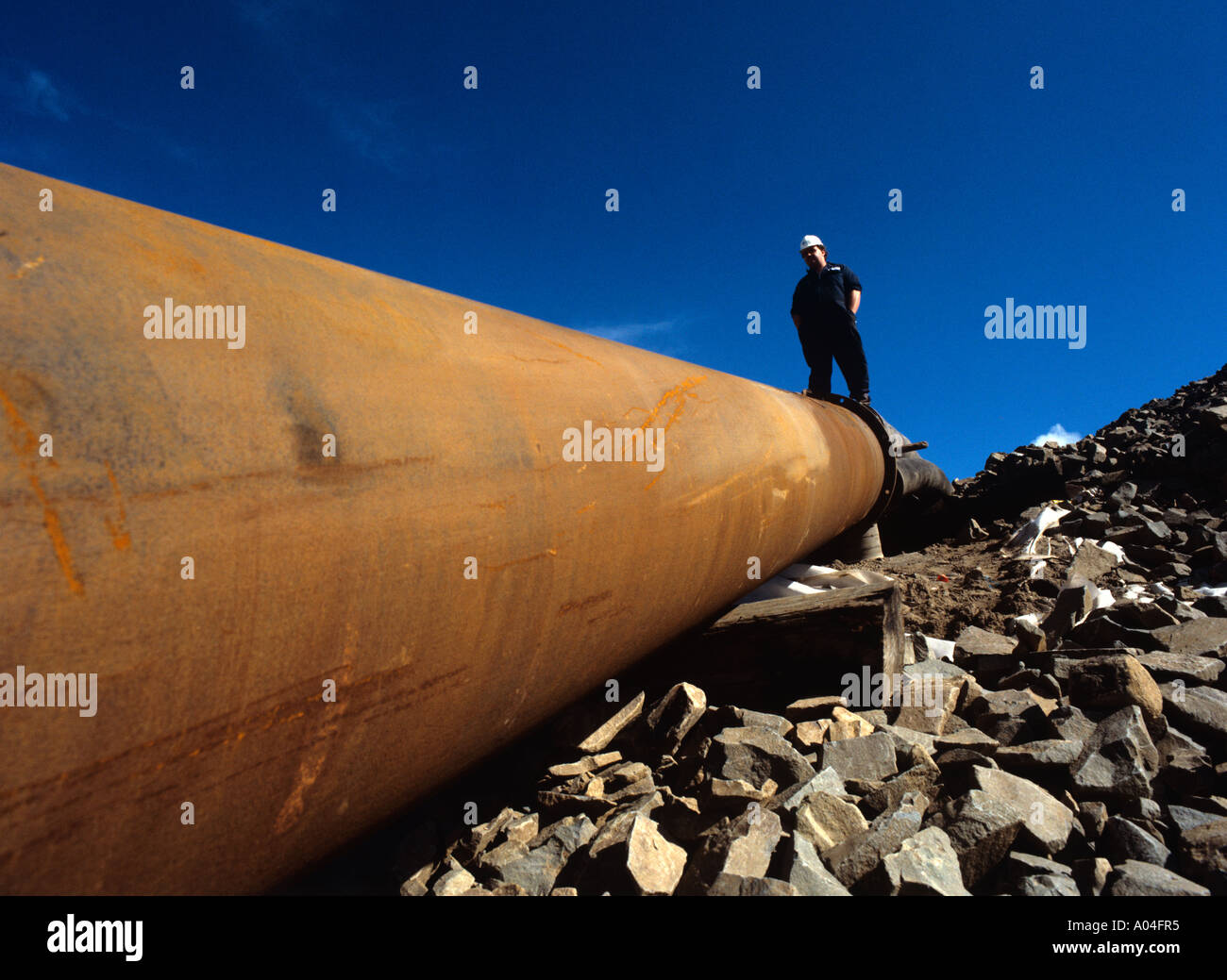 Industrial man on pipe Stock Photo - Alamy