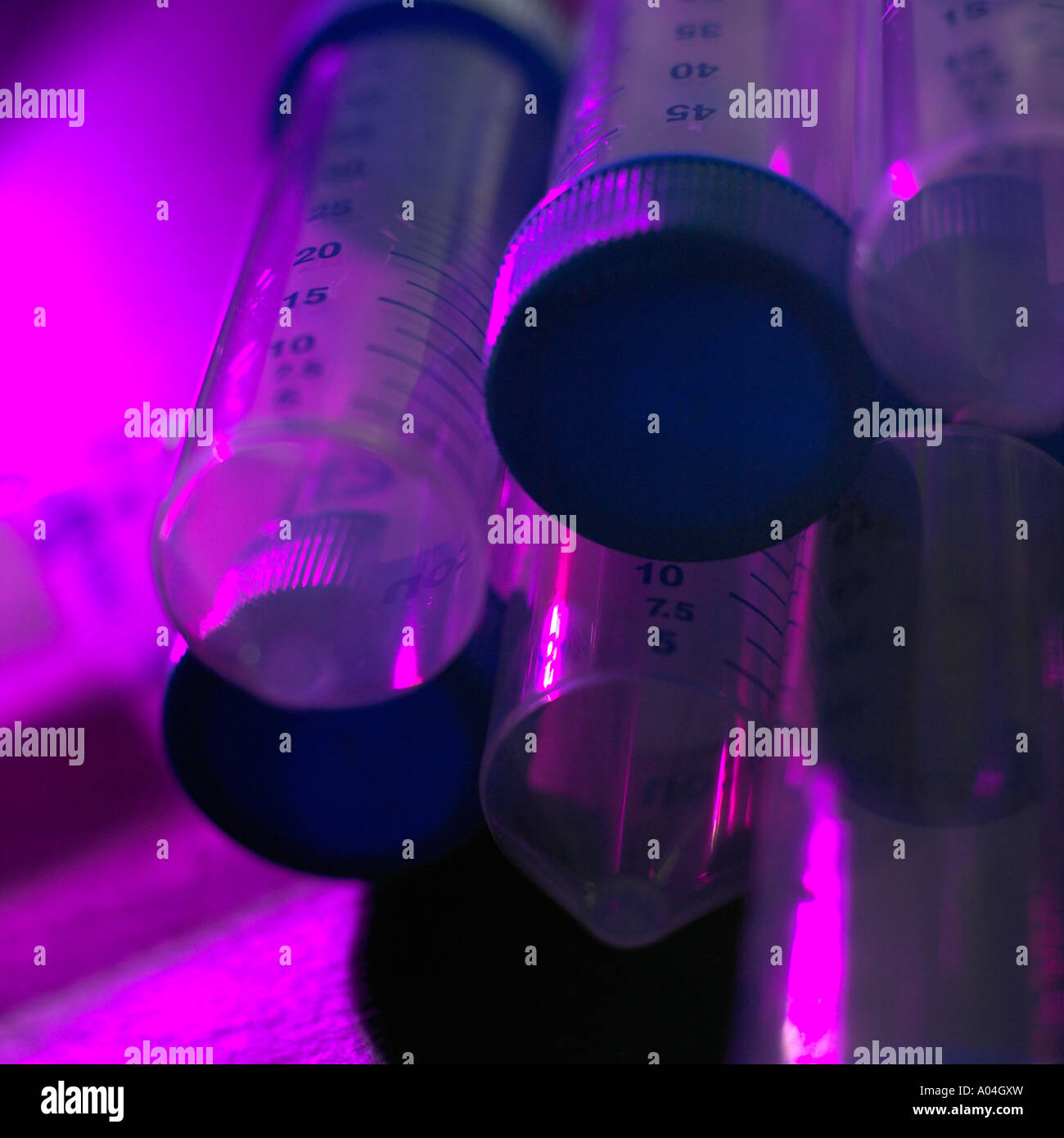 Group of Test Tubes in Purple light Stock Photo - Alamy
