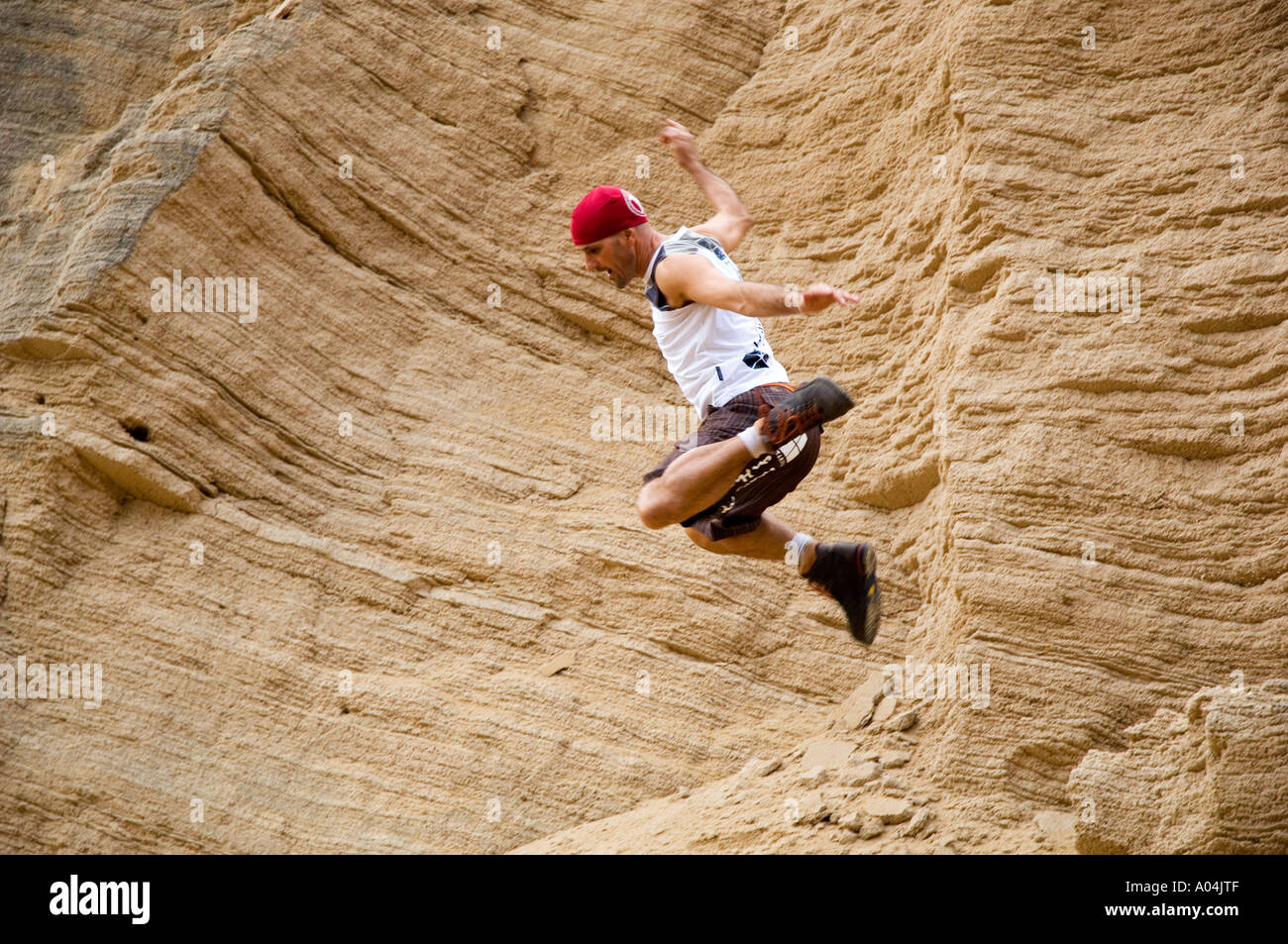 Full length shot of a man falling; background is of a well-defined ...