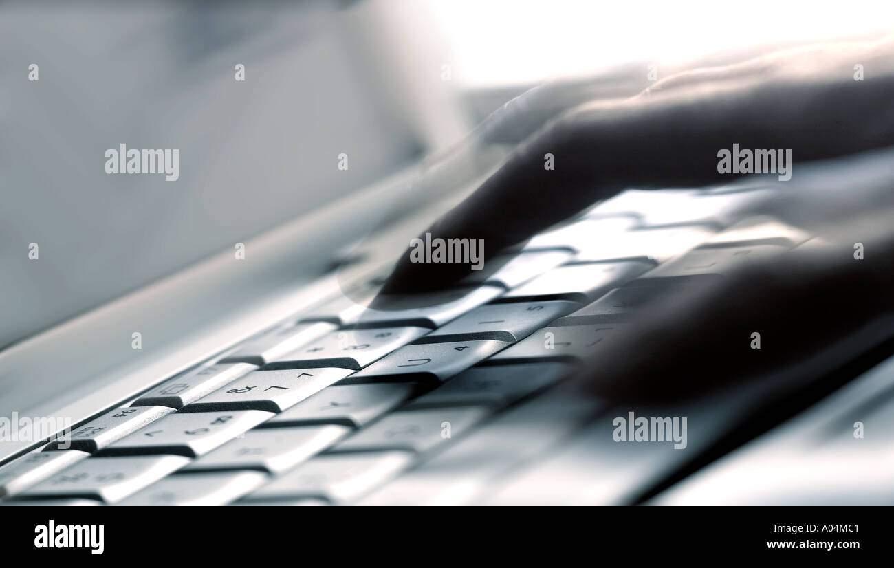 Landscape shot of laptop keyboard at low angle with hand adove showing ...