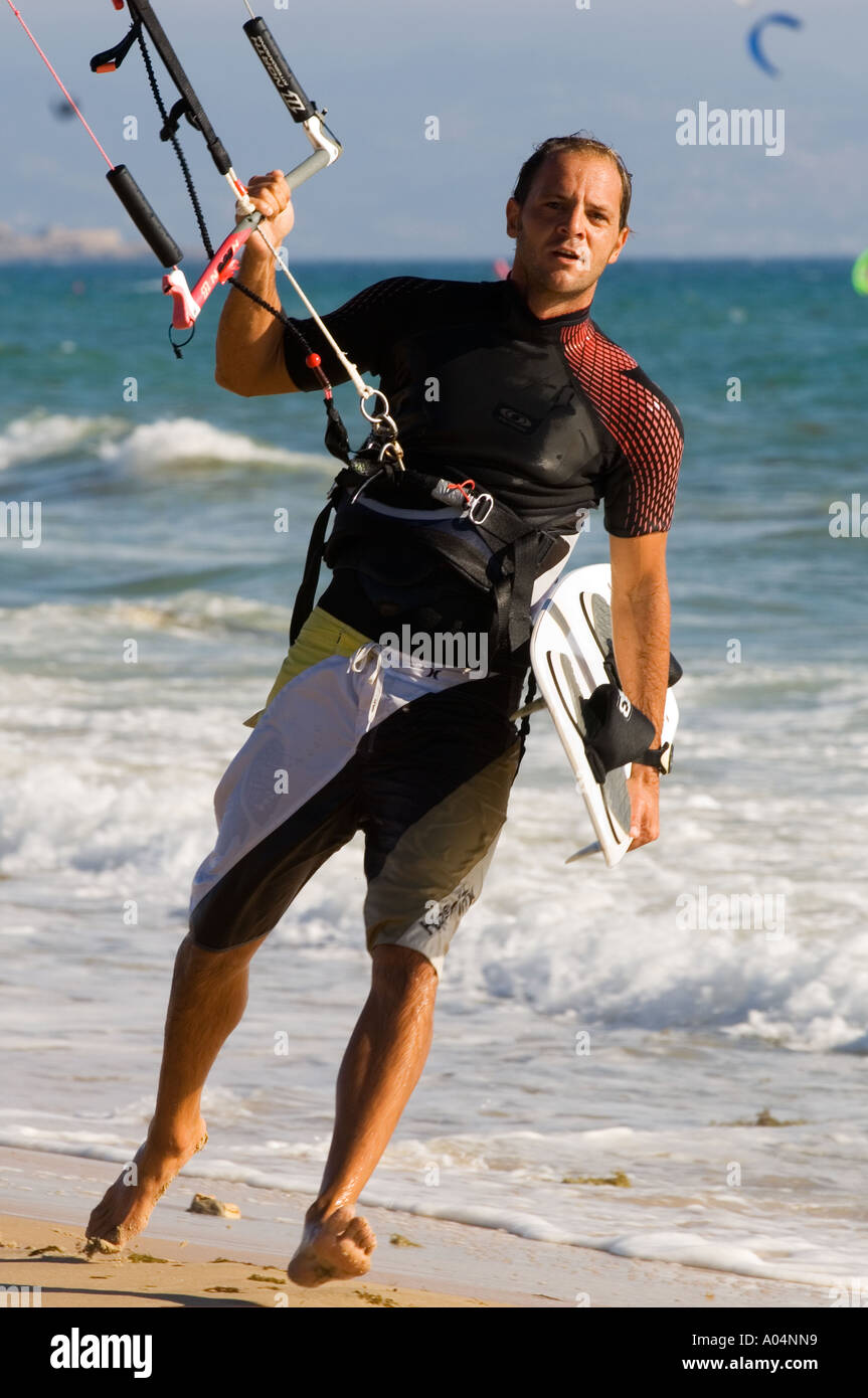 Full length view of a male kite surfer walking along the shore Stock ...