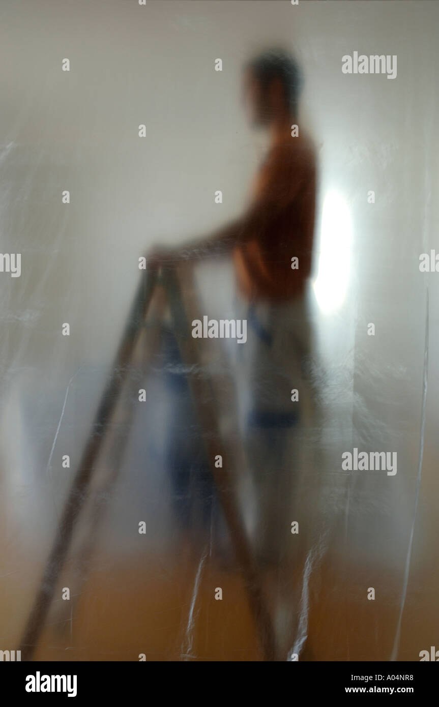 Conceptual side view image of a man standing on a ladder Stock Photo ...