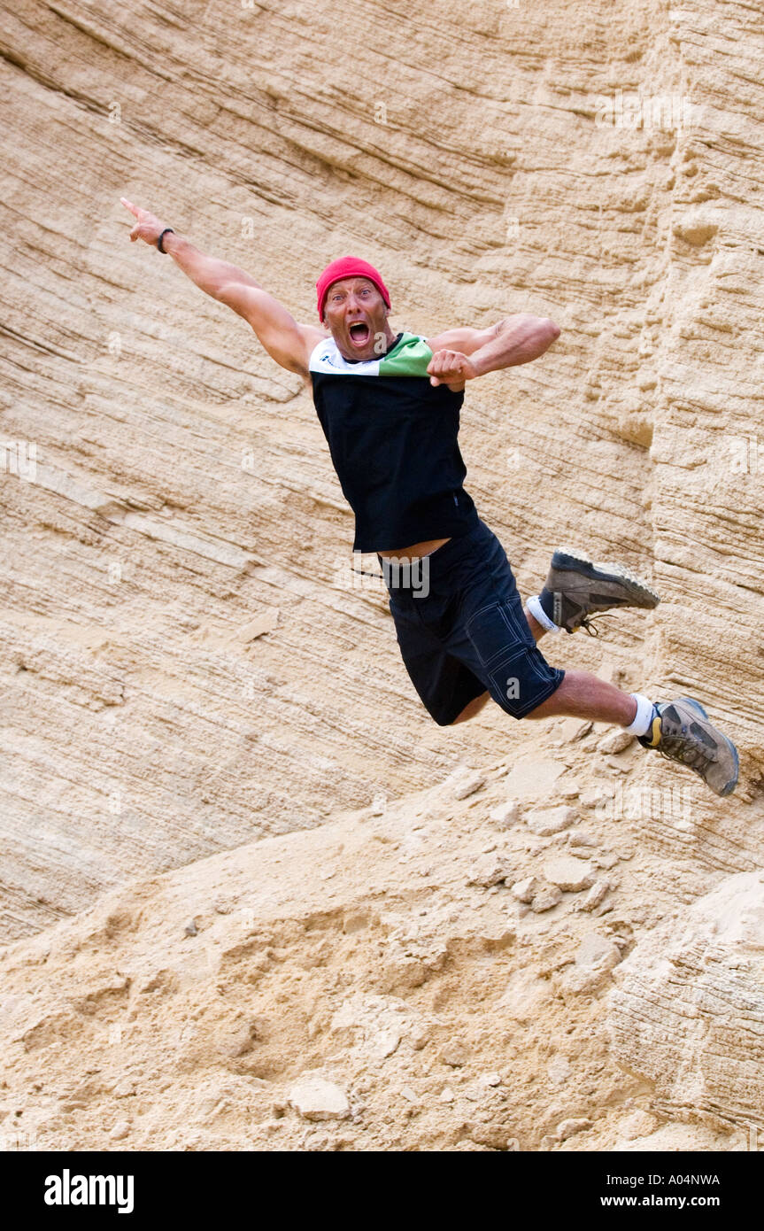 Full length shot of a man falling; background is of a beautifully ...