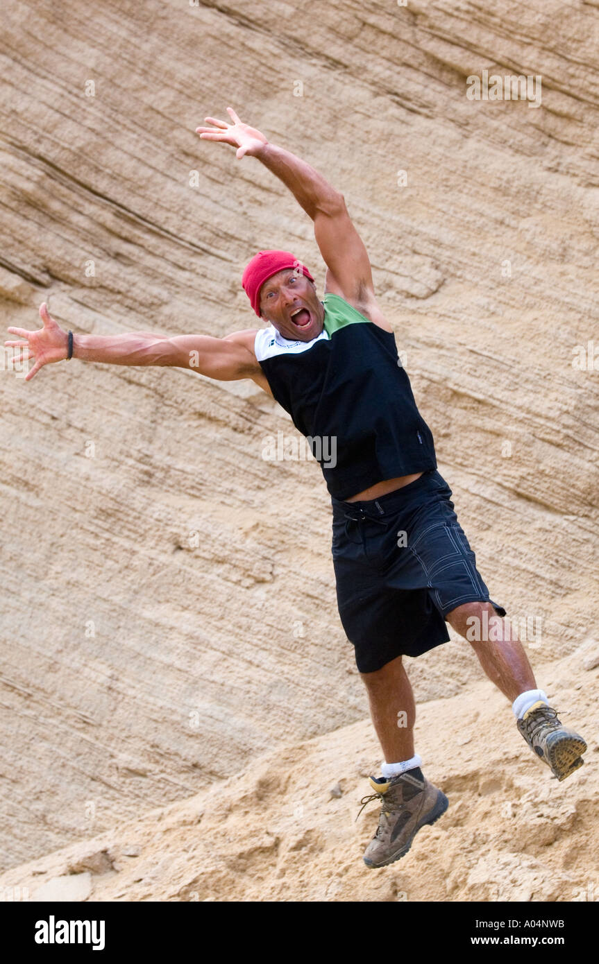 Full length shot of a man falling; background is of a beautifully ...