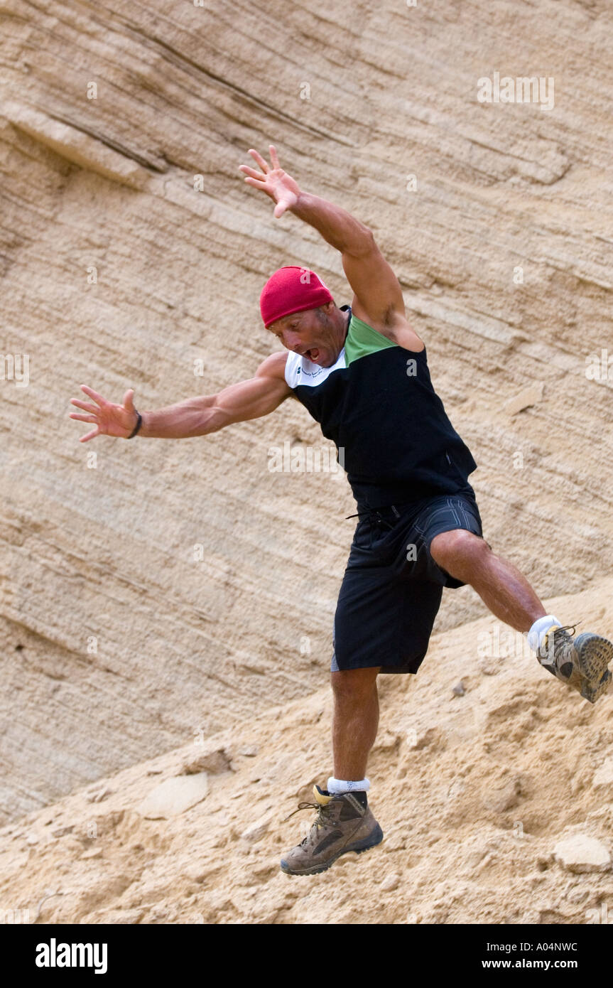 Full length shot of a man falling; background is of a beautifully ...