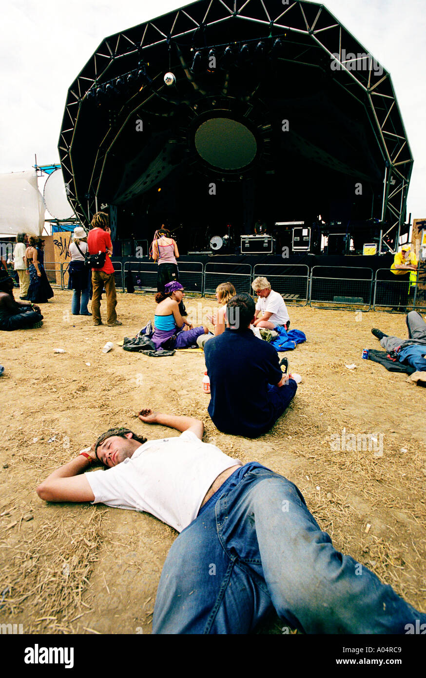 Guy snoozing at Glastonbury Stock Photo - Alamy