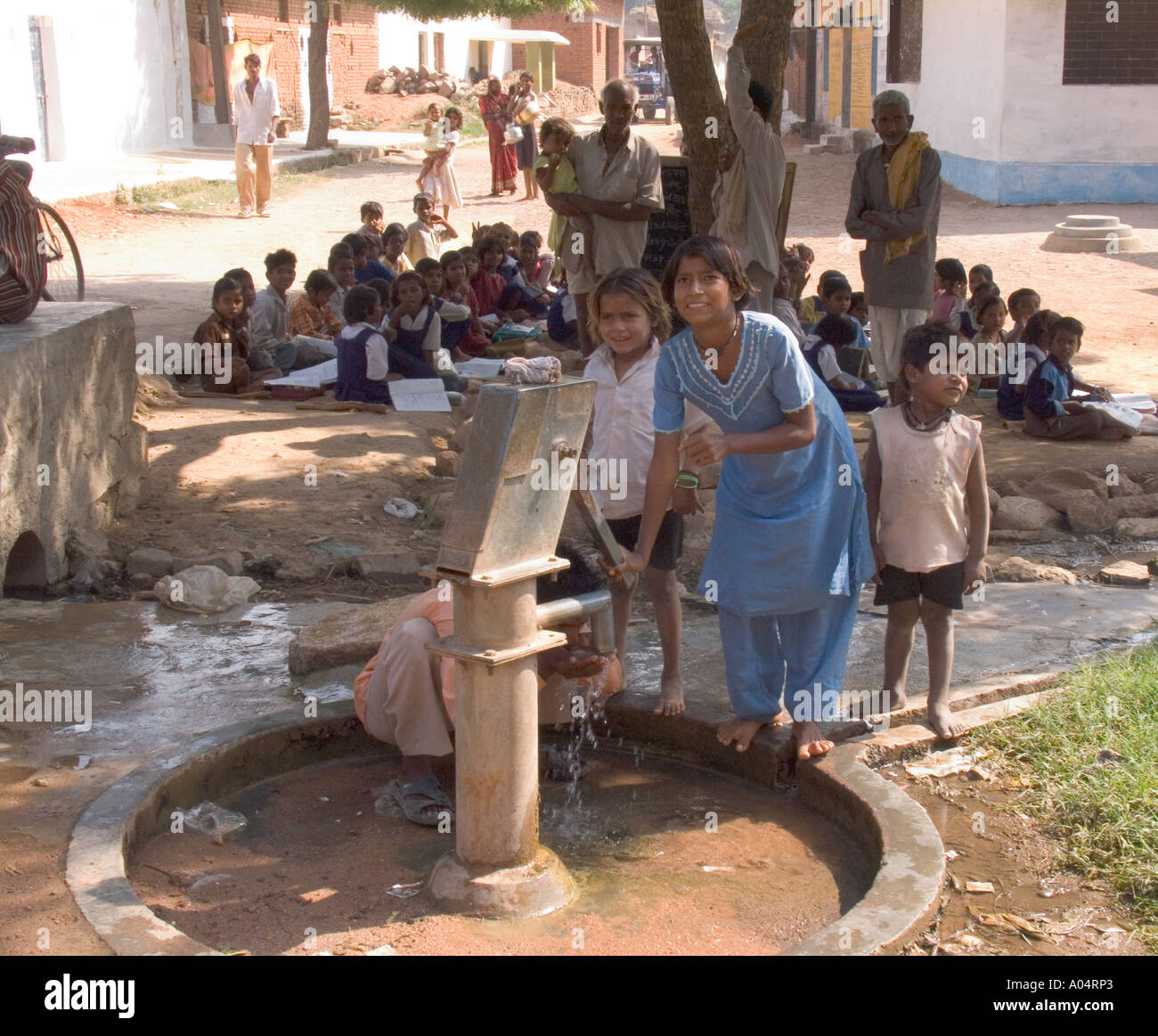 Villagers pumping water hi-res stock photography and images - Alamy
