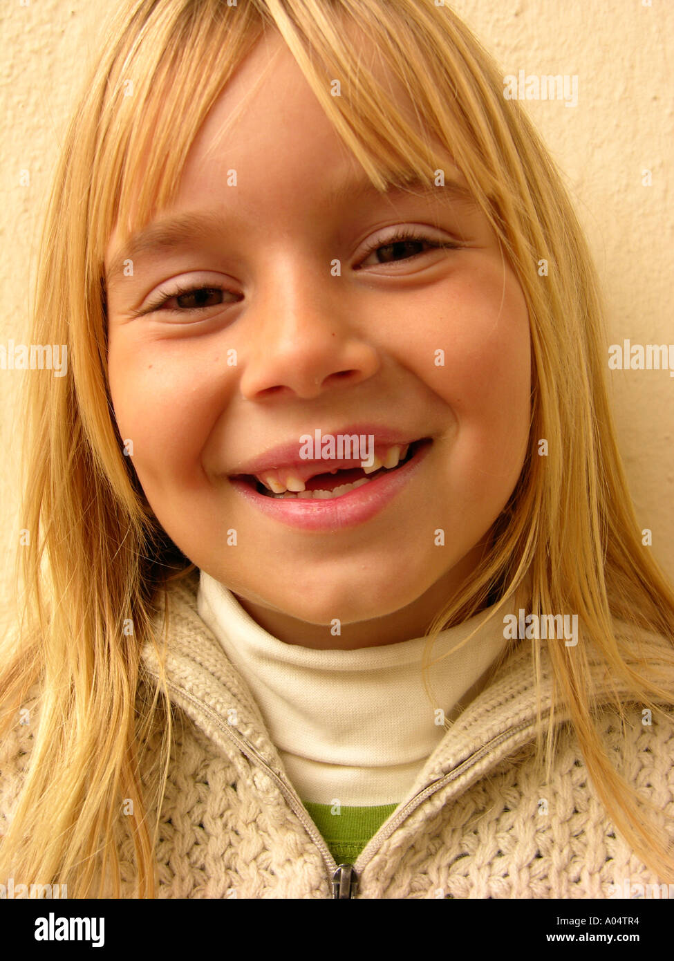 young blonde girl with her two front teeth missing, close up portrait Stock Photo - Alamy