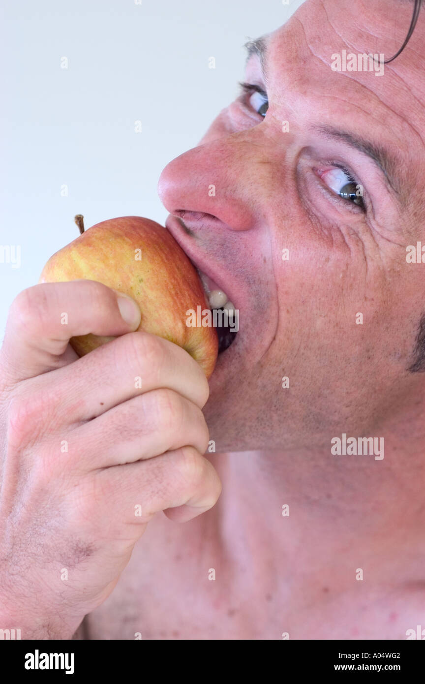 Man biting into an apple Stock Photo - Alamy