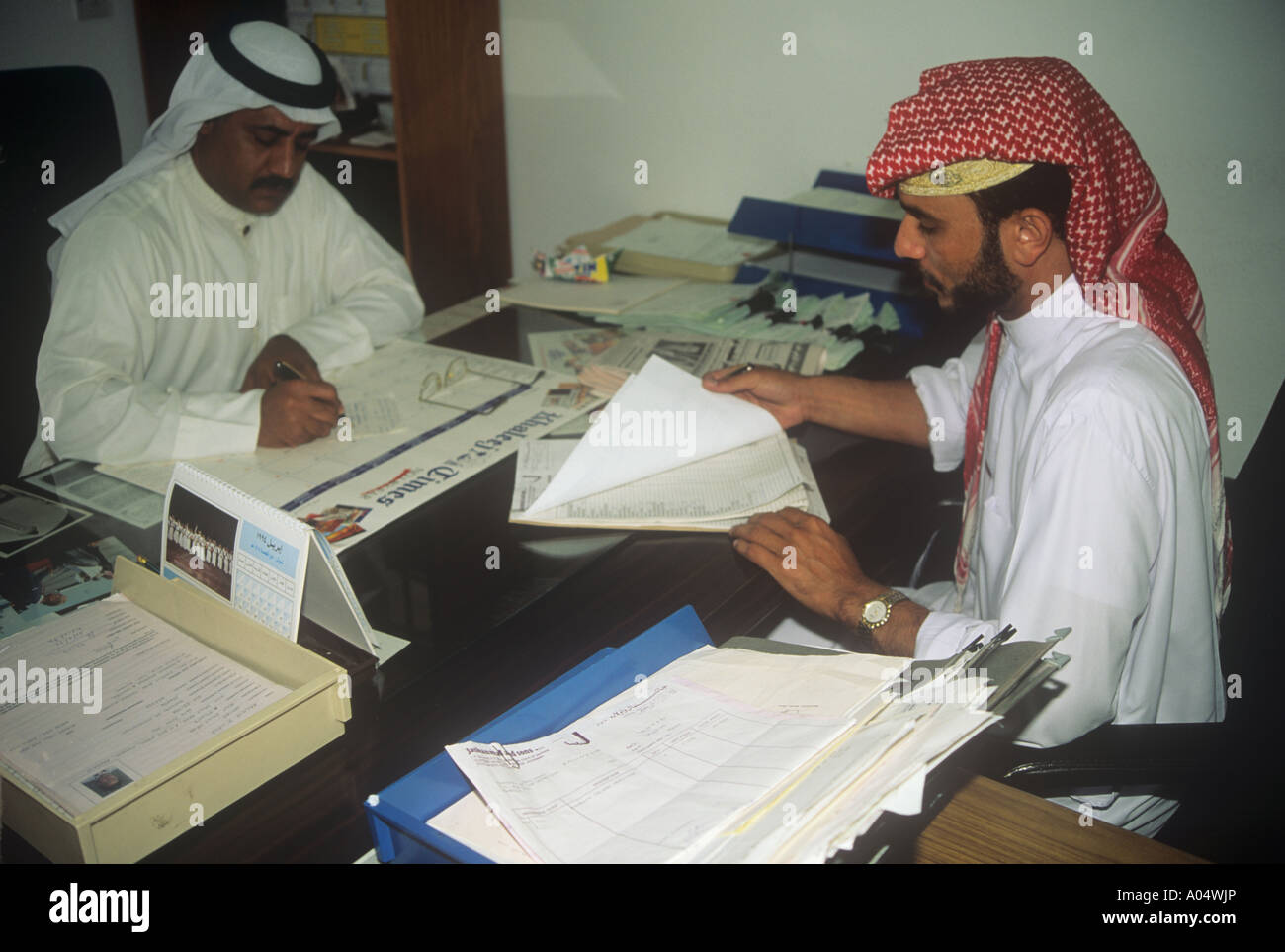 Two Arab men working in a government off ice in Manama Bahrain Stock ...