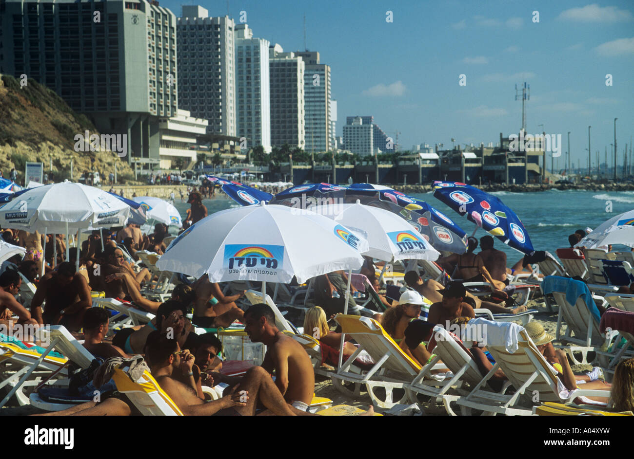 Crowded beach in summer parasols umbrellas hi-res stock photography and ...