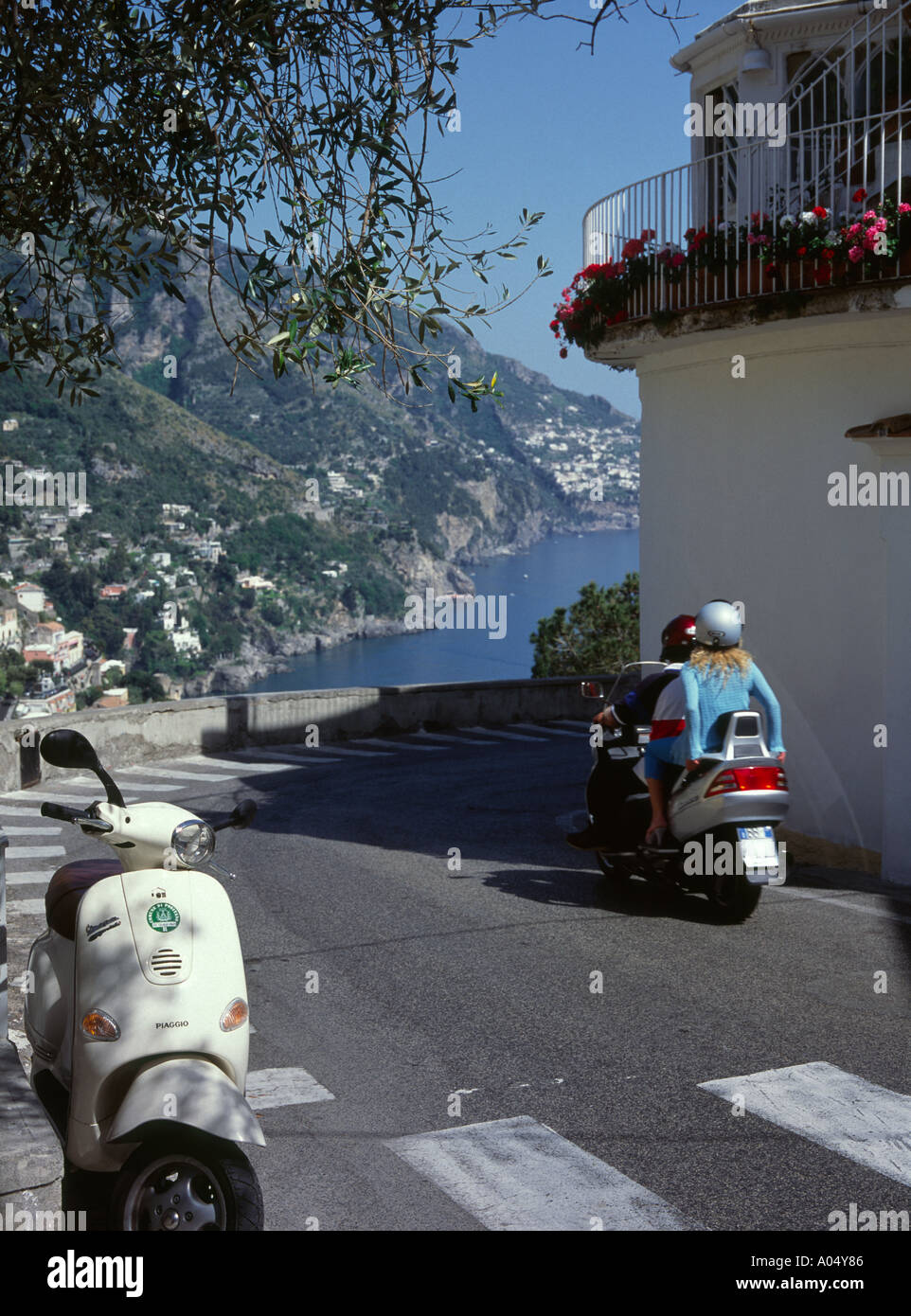 A couple scootering around the streets of Positano on the Amalfi coast ...