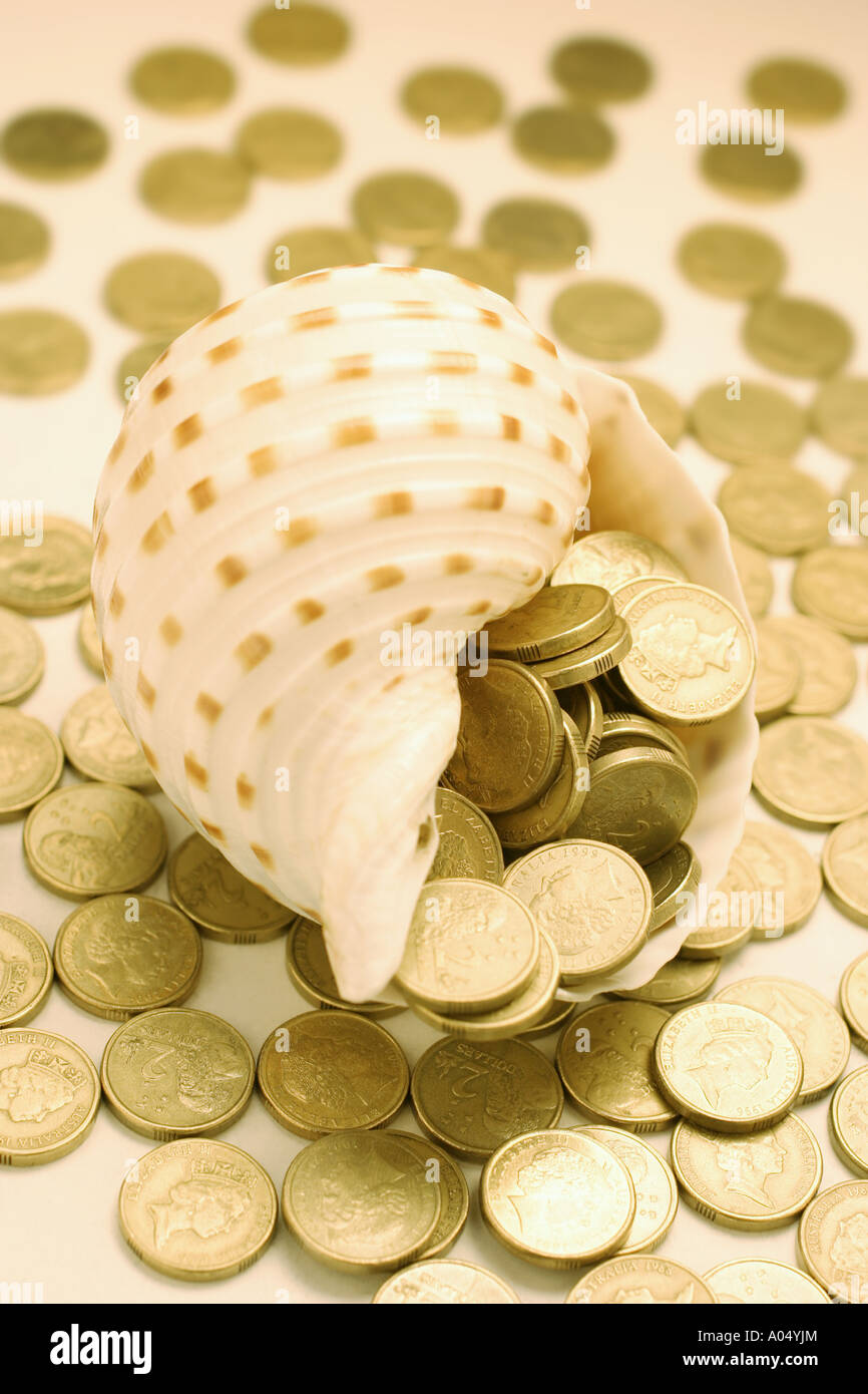 Coins in Seashell Stock Photo - Alamy