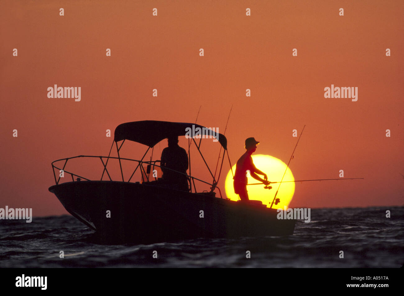 Fishing at sunset Stock Photo - Alamy