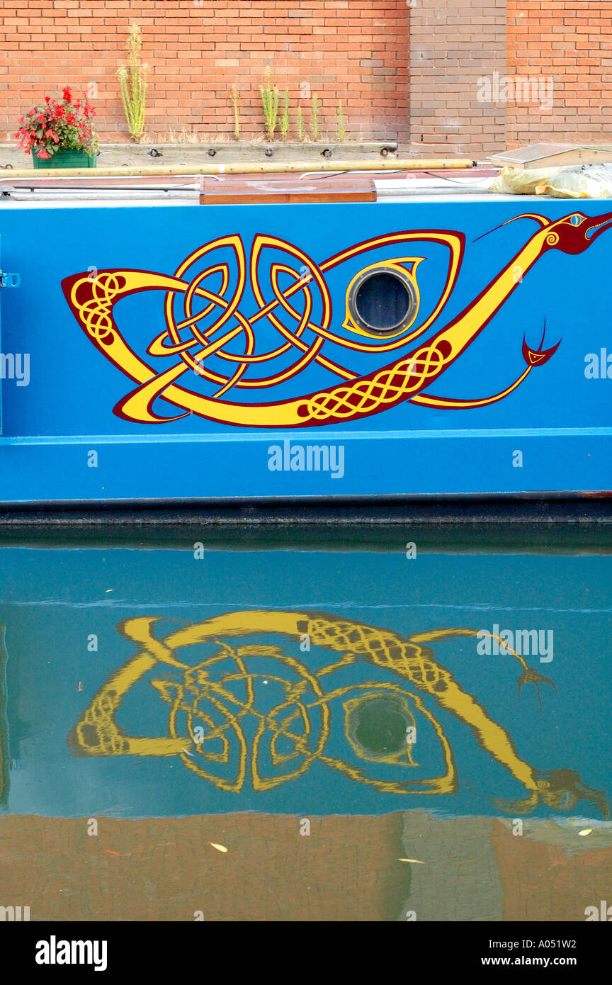 Bright blue narrowboat barge reflected in the canal, Regent's Canal ...