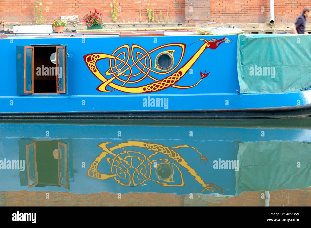 Bright blue narrowboat barge reflected in the canal, Regent's Canal ...