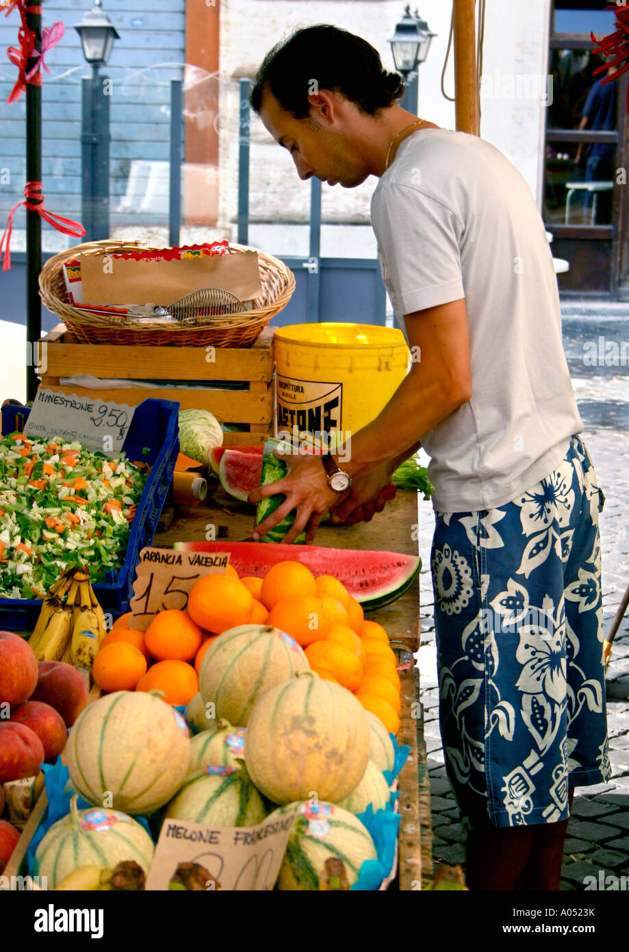 man chopping watermelon in the Campo dei Flori market, Rome, Italy ...