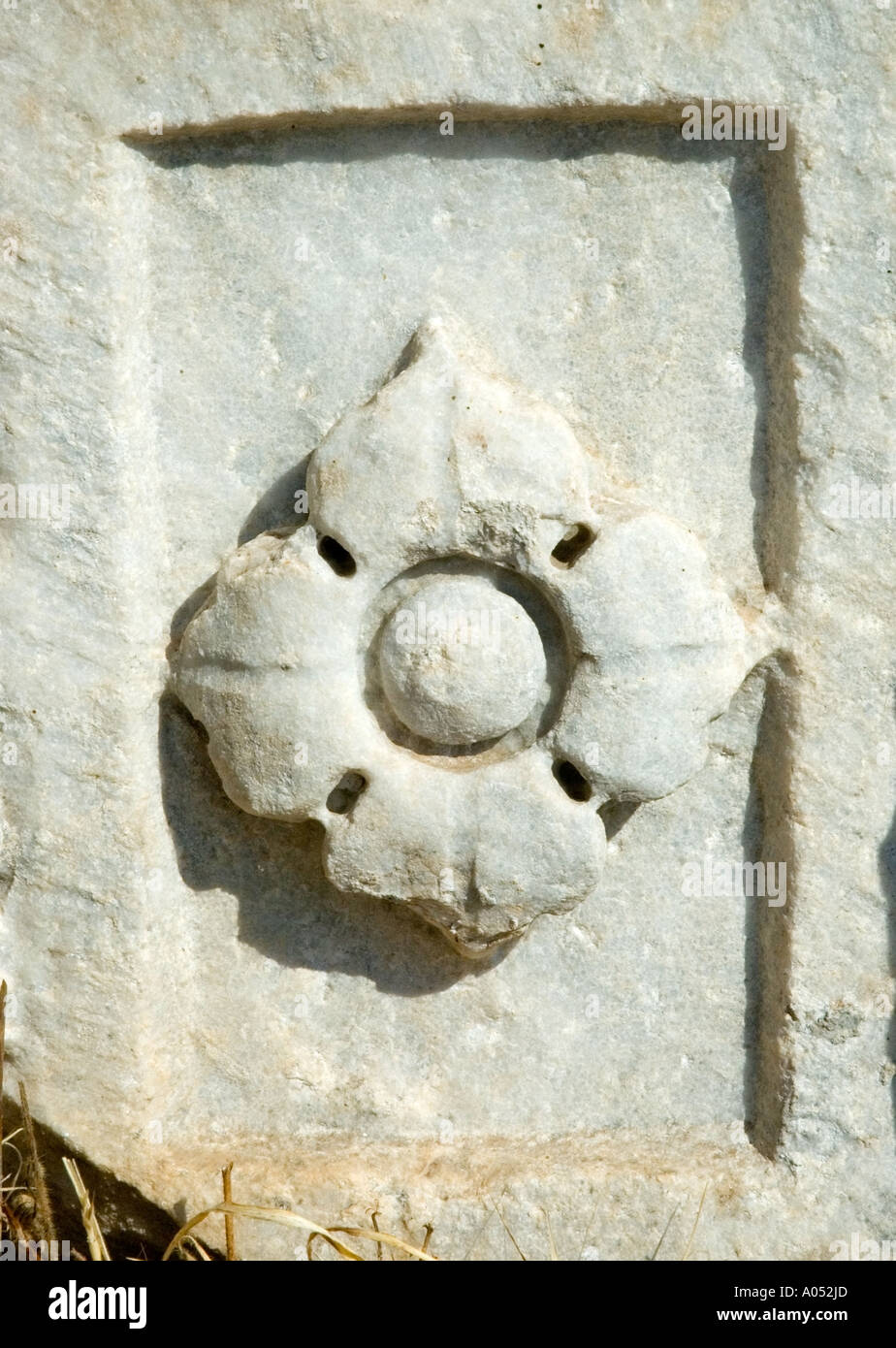 A floral emblem sculpted into a fallen decorative marble frieze panel ...