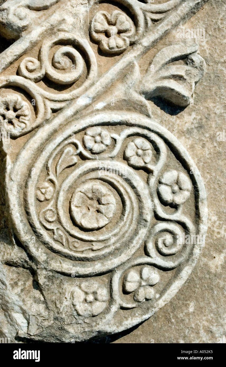 A floral spiral scroll emblem sculpted into a fallen decorative marble ...