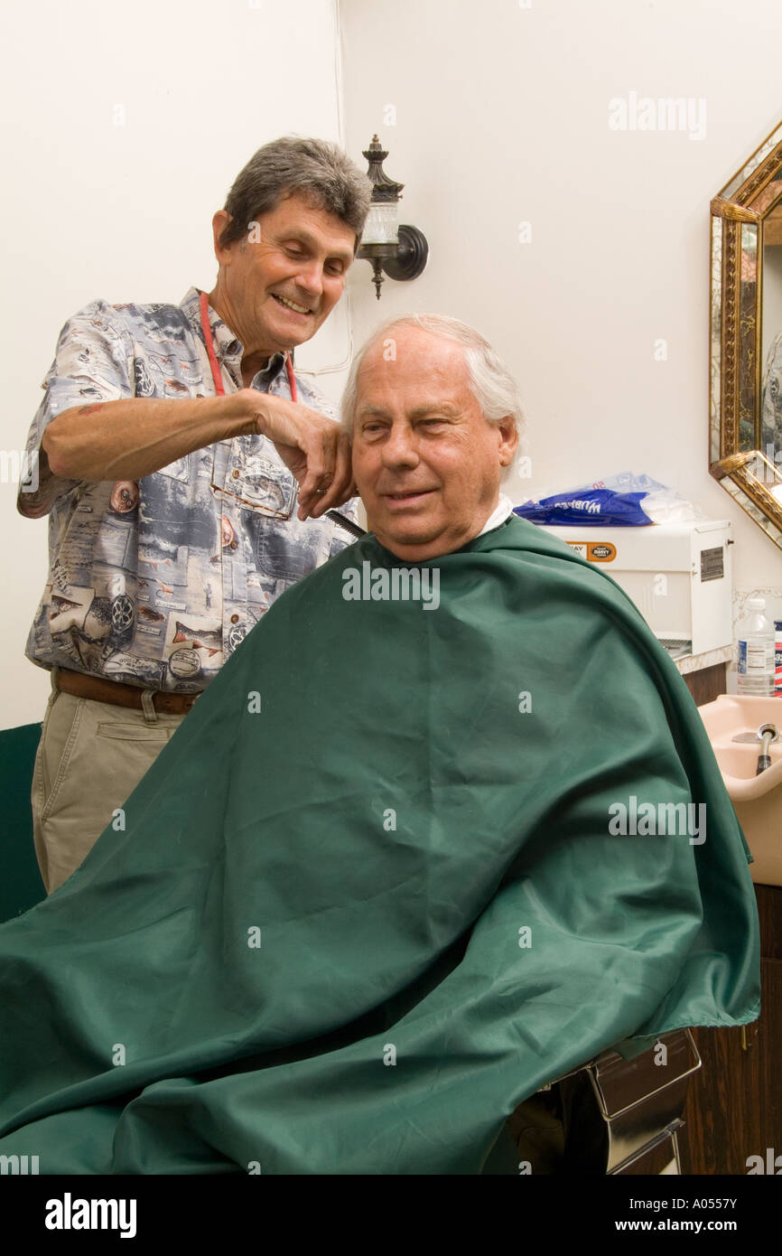 Small town America old fashioned barber shop with customers and talking ...