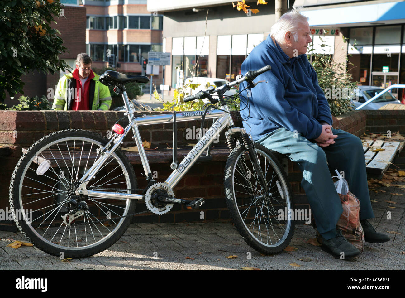old man taking rest in town centre Stock Photo - Alamy