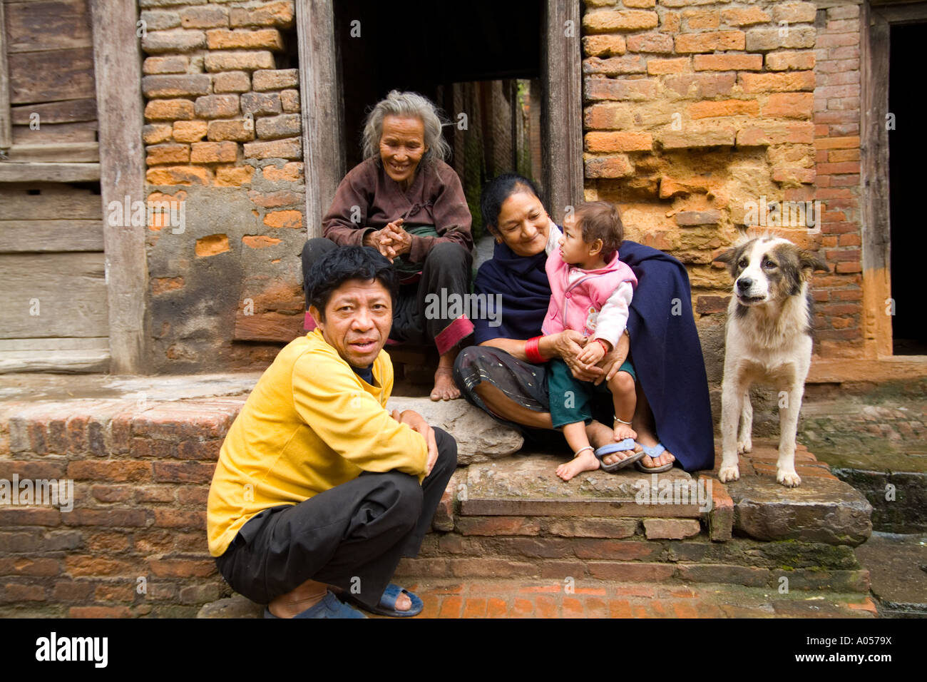 Family portrait of poor family outside their home in village of ...