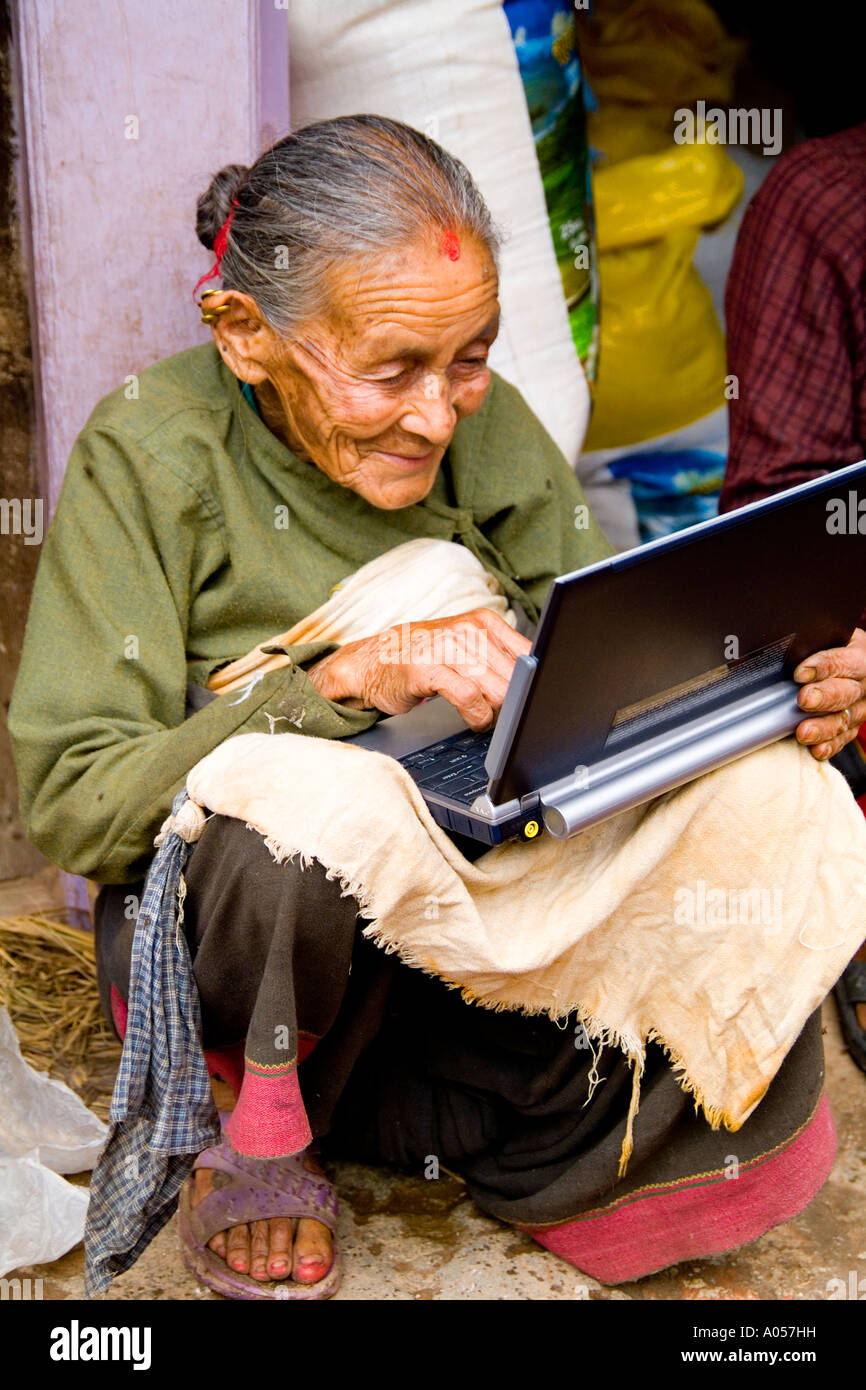 Great image of modern technology with old woman and new laptop computer ...