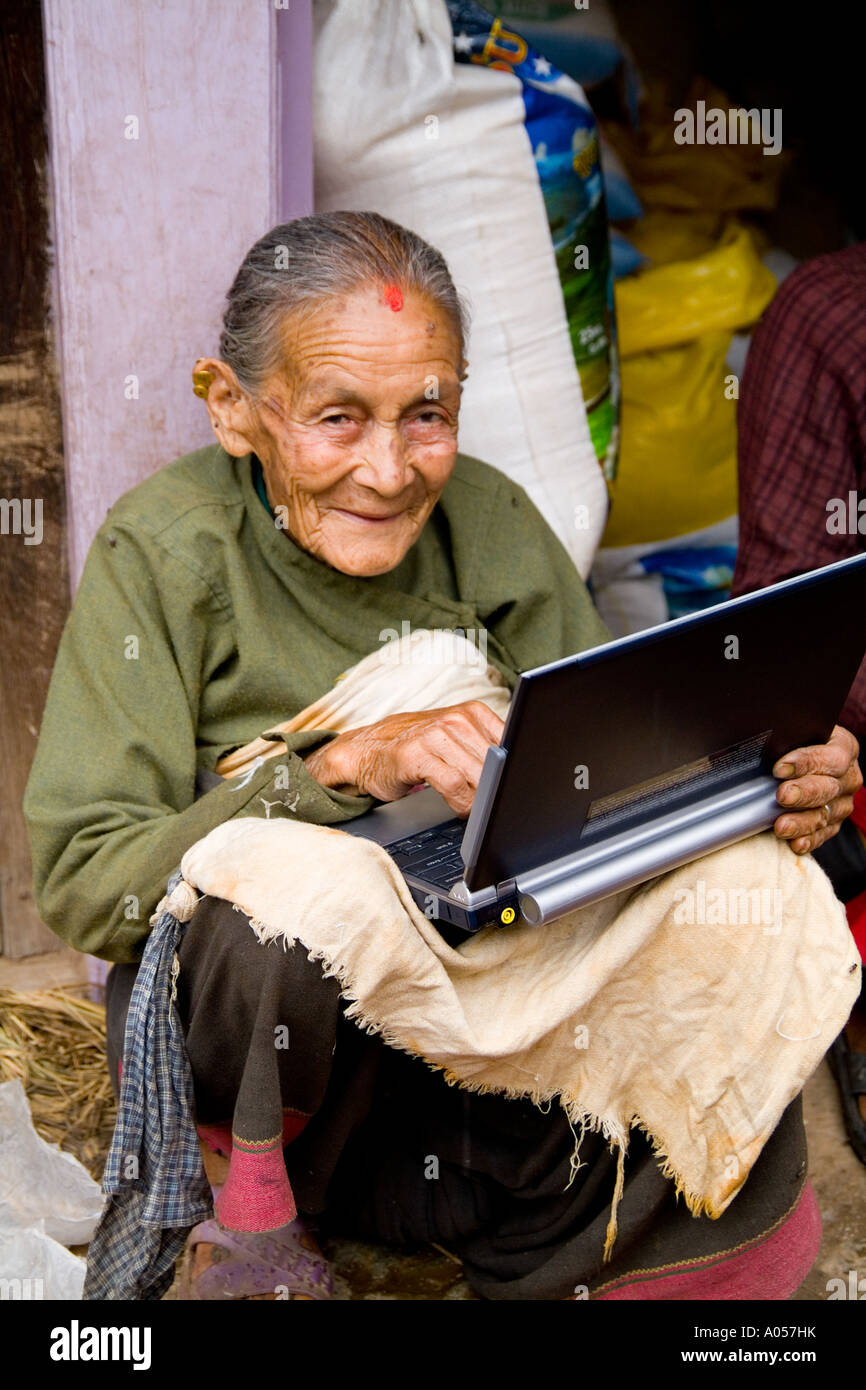Great image of modern technology with old woman and new laptop computer ...