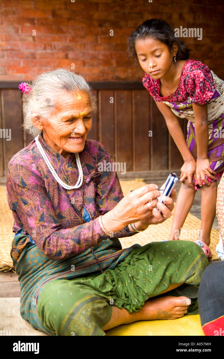 Great image of modern technology with old woman and new PDA computer in ...