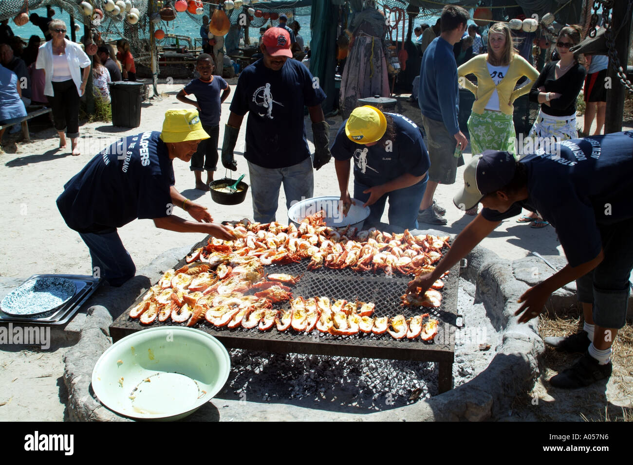 Crayfish being put onto open fire for cooking Beach restaurant western ...