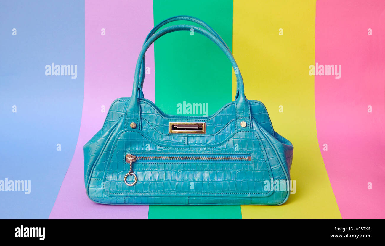 Teal handbag against rainbow background Stock Photo - Alamy