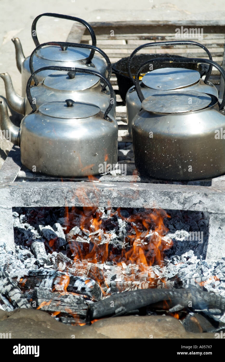 Kettles on the boil over an open fire Beach restaurant western cape ...